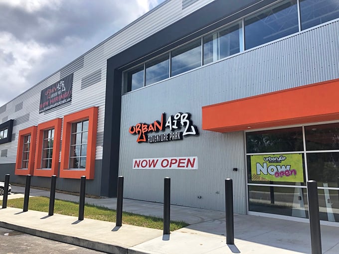 Urban Air's sleek exterior promises adventure within, the "NOW OPEN" sign practically daring you to rediscover your inner child.