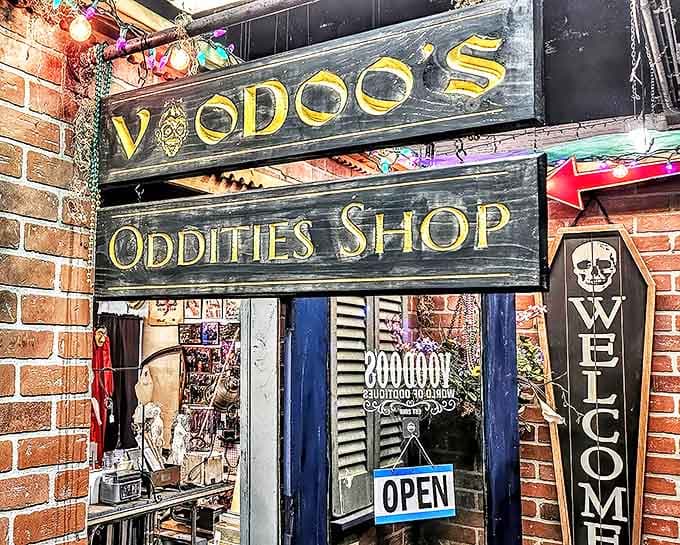 The weathered wooden sign of Voodoo's Oddities Shop beckons brave souls with its skull-adorned lettering and promises of the peculiar within.