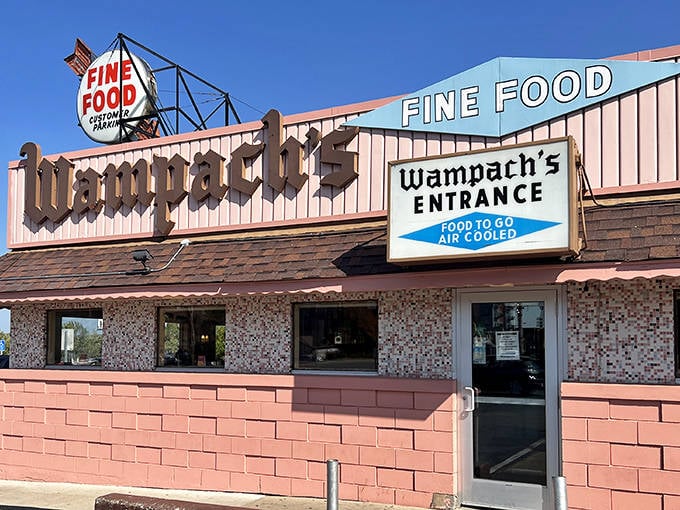 The iconic pink exterior of Wampach's beckons hungry travelers with its vintage "FINE FOOD" sign &ndash; a promise it's kept for generations.