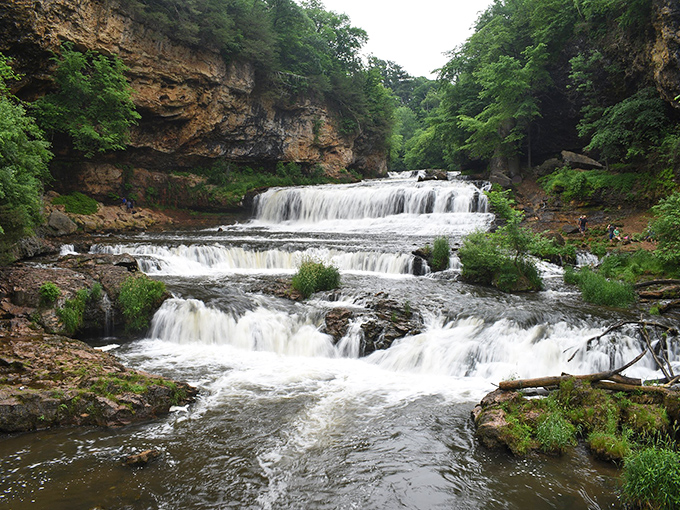 Willow Falls cascades dramatically over limestone ledges, creating a three-tiered natural masterpiece that's worth every step of the journey.