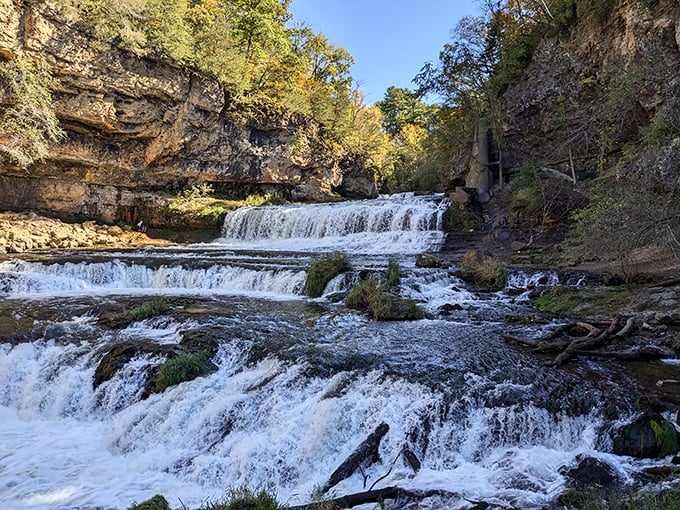 Nature's perfect staircase: Willow Falls cascades over limestone shelves, creating a mesmerizing multi-tiered waterfall that hypnotizes visitors year-round.
