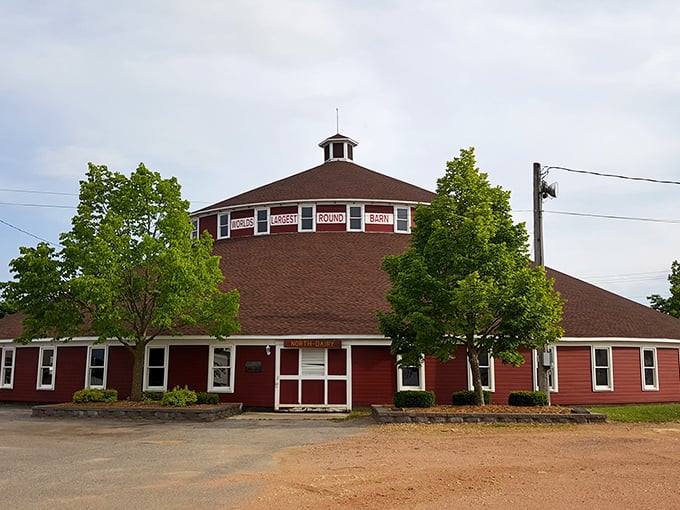 The iconic red exterior of the World's Largest Round Barn stands proudly in Marshfield, Wisconsin, a circular marvel against the rural landscape.