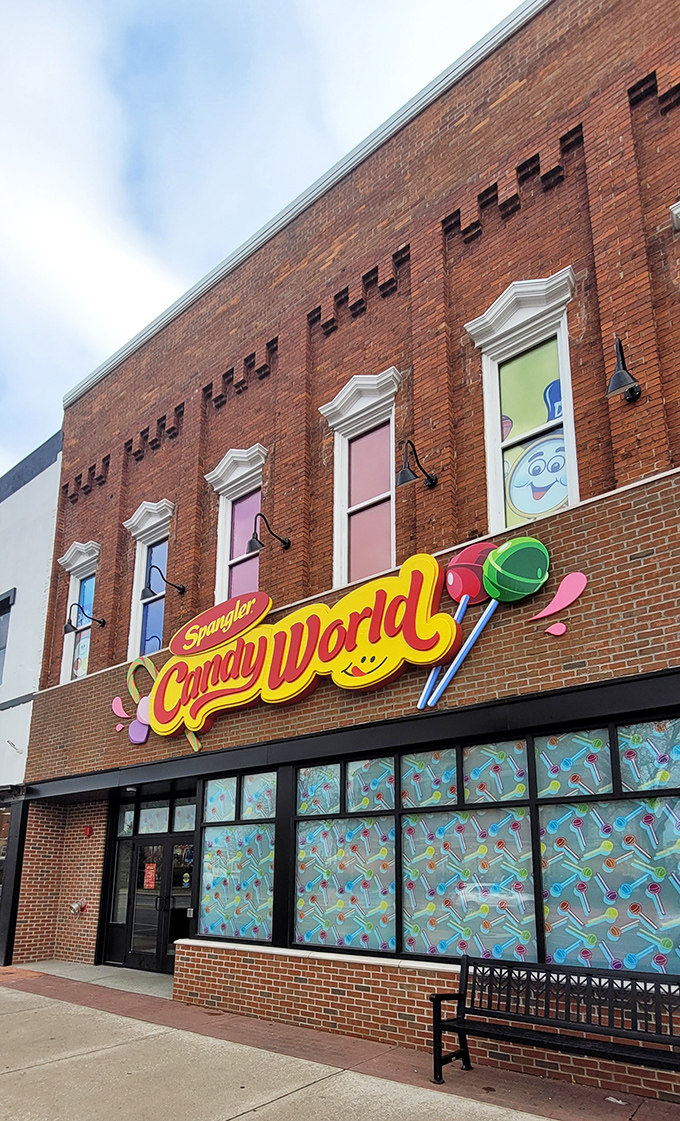 The vibrant brick façade of Spangler Candy World beckons with its cheerful lollipop signage, promising sweet adventures within Bryan's most colorful destination.
