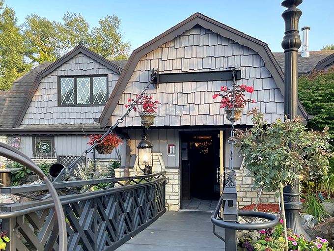 The storybook exterior of The English Inn beckons with its distinctive barn-like architecture and hanging flower baskets, promising old-world charm inside.