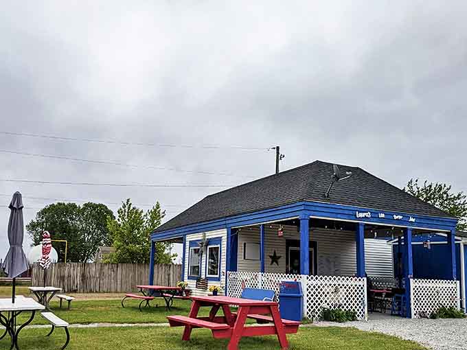 The charming blue-trimmed exterior of Laura's Little Burger Joint stands as a beacon for burger lovers, promising homestyle perfection in Decatur's countryside.