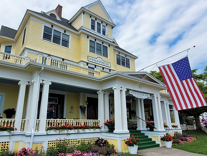 The sunshine-yellow Windermere Hotel stands proudly with its white columns and American flag, like a Victorian grande dame dressed in her Sunday best.