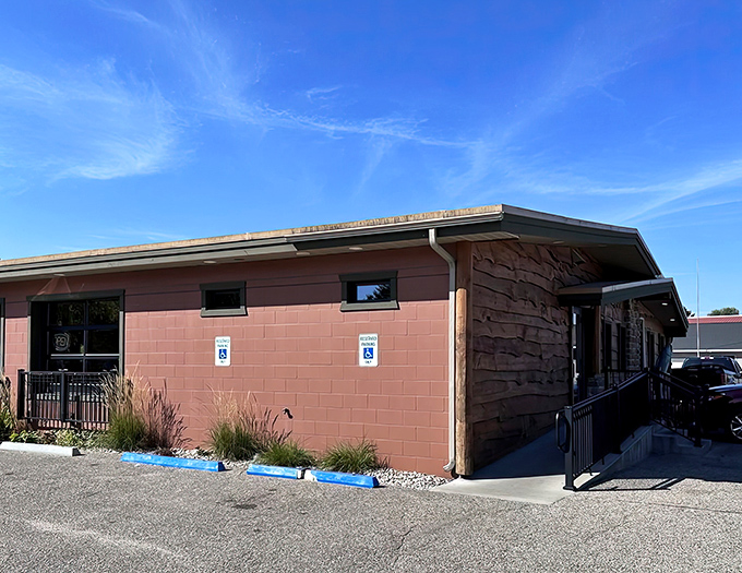 The unassuming exterior of Trout Town Tavern & Eatery hides a culinary treasure within its rustic walls and stone accents.