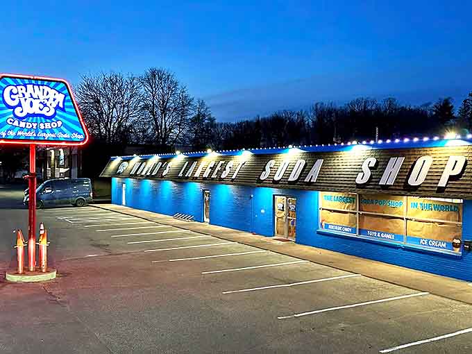 The electric blue exterior of Grandpa Joe's glows like a neon beacon of sweetness against the Minnesota sky, promising sugary treasures within.