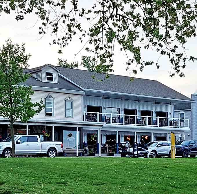 The charming white exterior of Marine City Fish Company welcomes visitors with its wraparound porch and prime riverfront location &ndash; a seafood sanctuary disguised as a classic Michigan home.