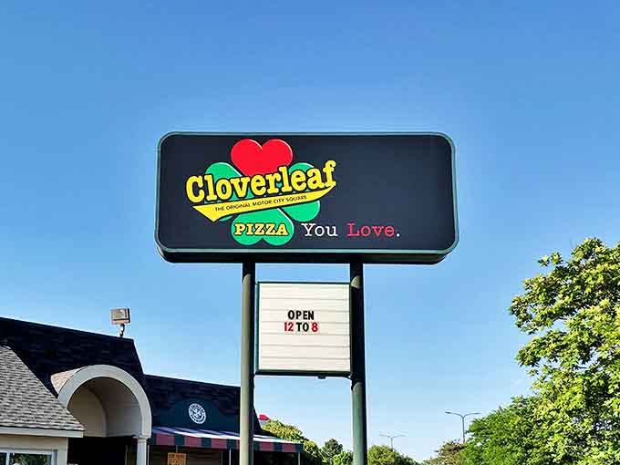 The iconic Cloverleaf sign stands proud against the Michigan sky, promising square pizza perfection to all who enter this Eastpointe landmark.