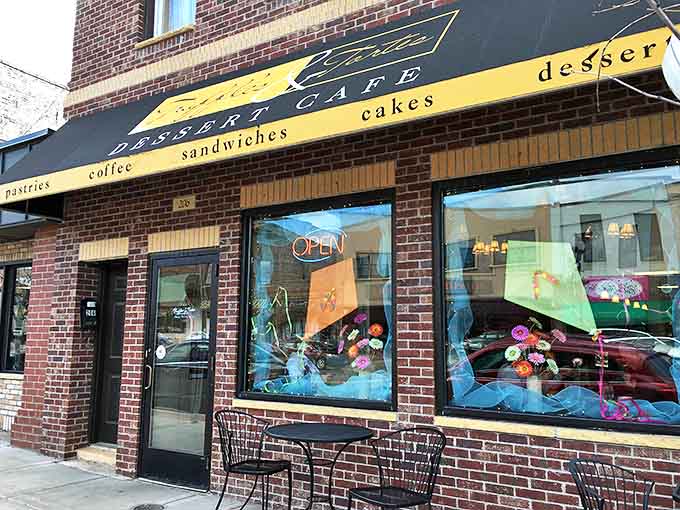 The inviting brick facade of Truffles & Tortes beckons with promises of sweetness, its yellow awning like a sugary beacon in downtown Anoka.