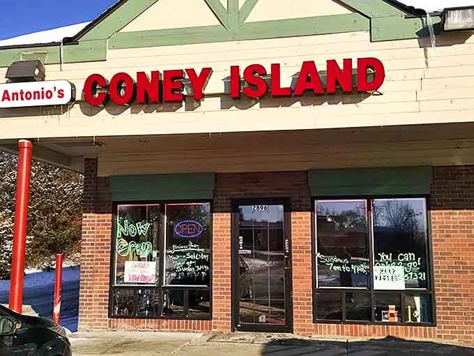 Antonio's Coney Island exterior beckons with its bright red signage &ndash; a culinary plot twist waiting to happen in this Michigan strip mall.