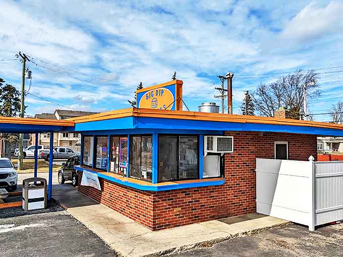 The iconic blue and orange exterior of Big Dip Burgers stands like a beacon of hope for hungry travelers seeking burger nirvana.