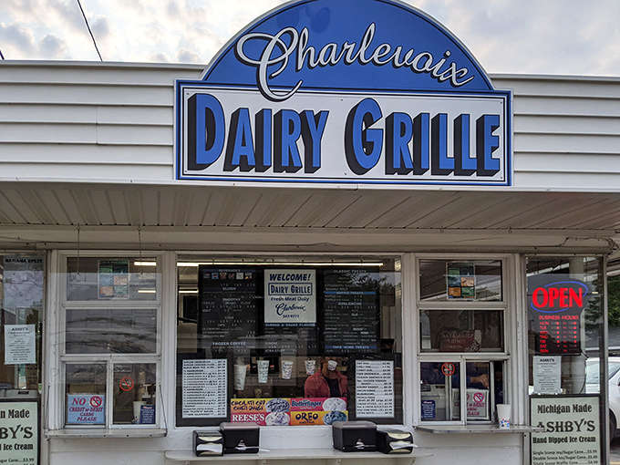 The iconic blue and white sign of Charlevoix Dairy Grille welcomes hungry visitors &ndash; a humble facade hiding culinary greatness within.