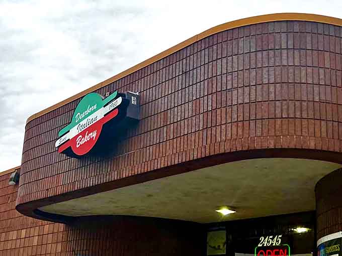 The iconic brick exterior of Dearborn Italian Bakery stands as a culinary landmark, promising Italian treasures within its unassuming walls.