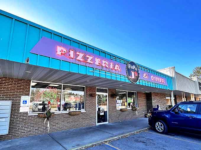 The turquoise facade of Papa J's Pizzeria & Diner glows with retro charm, beckoning hungry travelers into a time capsule of flavor.