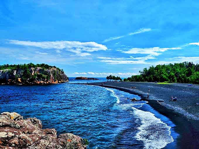 Black Beach offers a striking contrast of dark sand against Superior's blue waters, where volcanic rock meets the world's largest freshwater lake.