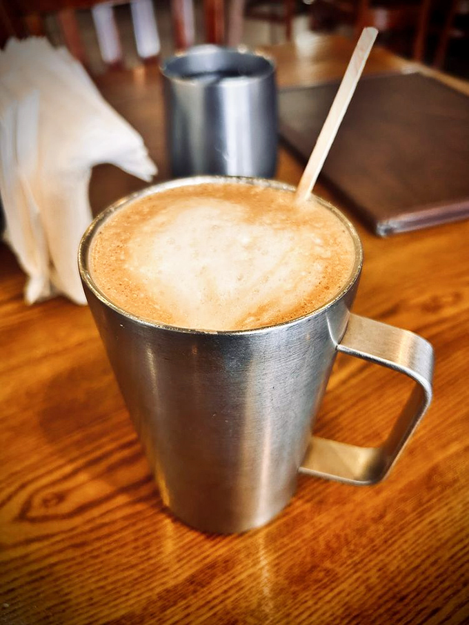 Strong Cuban coffee mellowed with steamed milk, served in a metal mug that keeps it hot enough to warm both hands and soul.