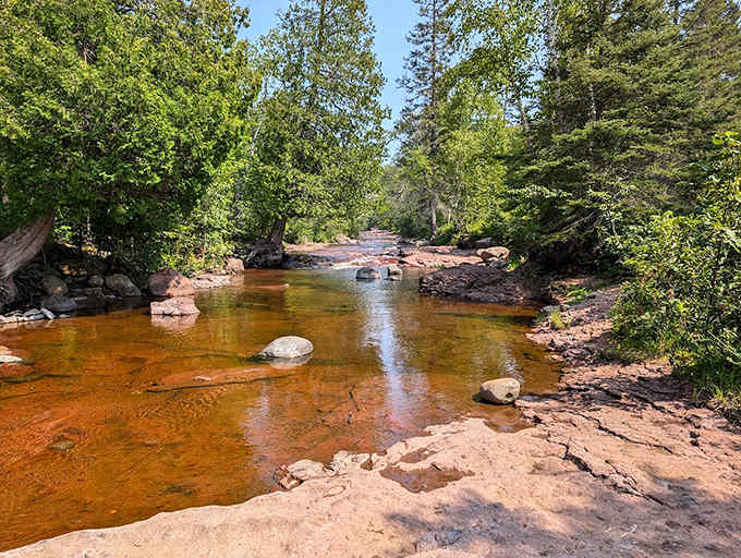 Shallow rock shelves create natural pools and mini-rapids, perfect for cooling tired feet after your hike.