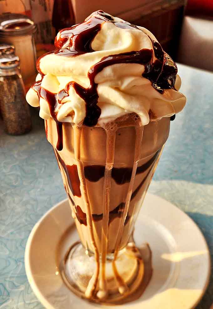 This isn't just a milkshake &ndash; it's a tower of creamy indulgence that requires both a straw and spoon to properly appreciate.