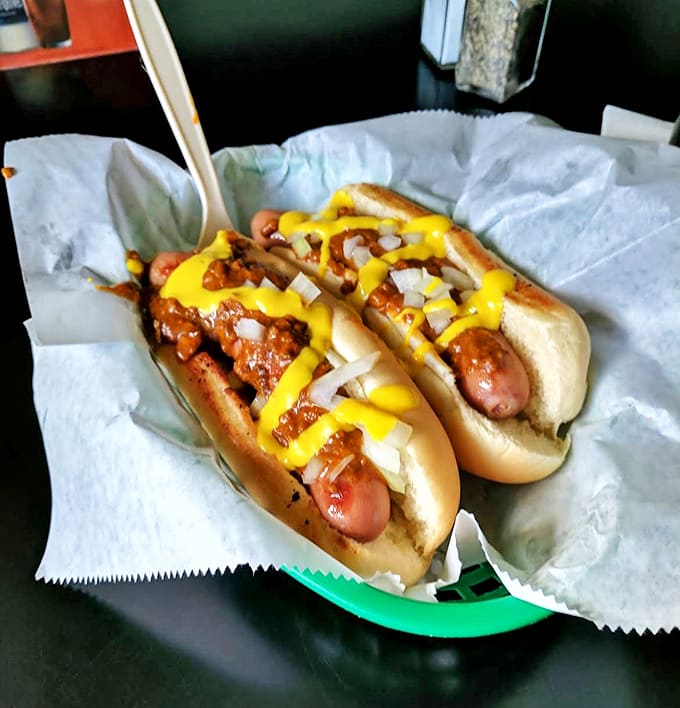 Coney Dogs: Michigan's beloved hot dog tradition done right &ndash; smothered in chili, mustard, and onions. A beautiful mess worth every bite.