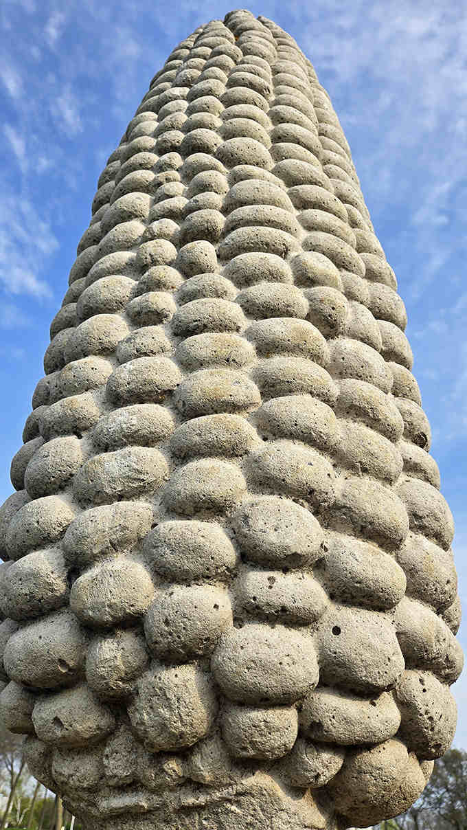 Up close, the detailed craftsmanship of each concrete kernel becomes apparent, showcasing the meticulous artistry behind this whimsical installation.
