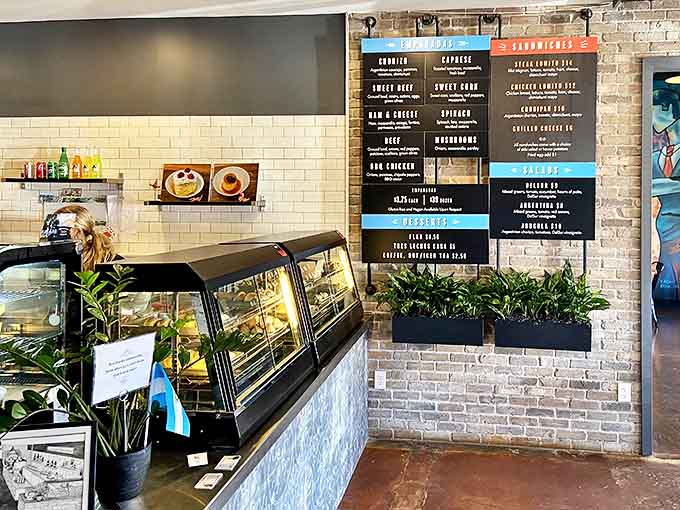 Order at the counter, but linger at your leisure. The display case showcases freshly baked empanadas, each variety with its own distinctive crimp pattern.