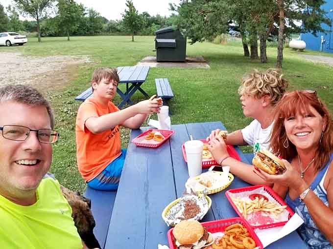 Happy families making memories around picnic tables – the true measure of Laura's success isn't just great food but the joy it creates.