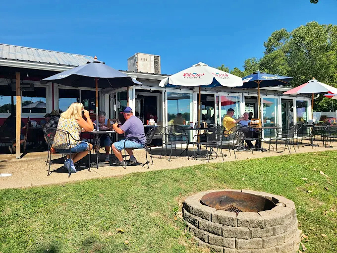 The outdoor patio becomes a community gathering spot where strangers become friends over shared appreciation of smoke and sauce.