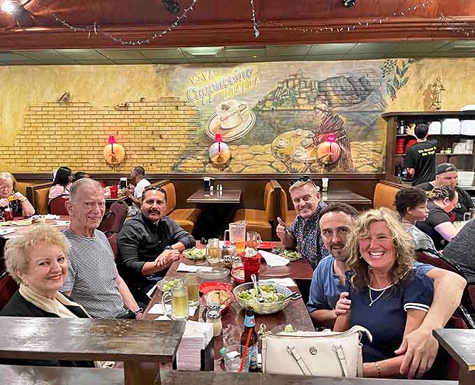 Happy diners gathered around tables, proving that great food creates the kind of community that no social media platform can replicate.
