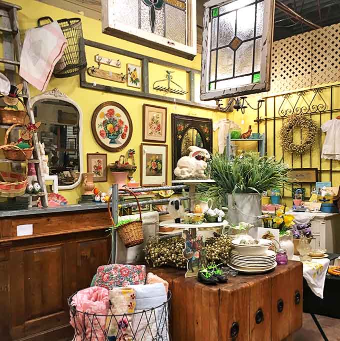 Sunny yellow walls provide the perfect backdrop for this cheerful collection of vintage kitchenware, linens, and garden-fresh decorative elements.
