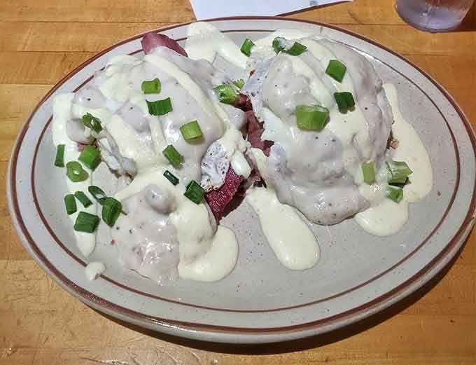 Eggs Fitzgerald &ndash; where poached eggs float on corned beef hash islands in a sea of creamy hollandaise sauce. Poetry on a plate!