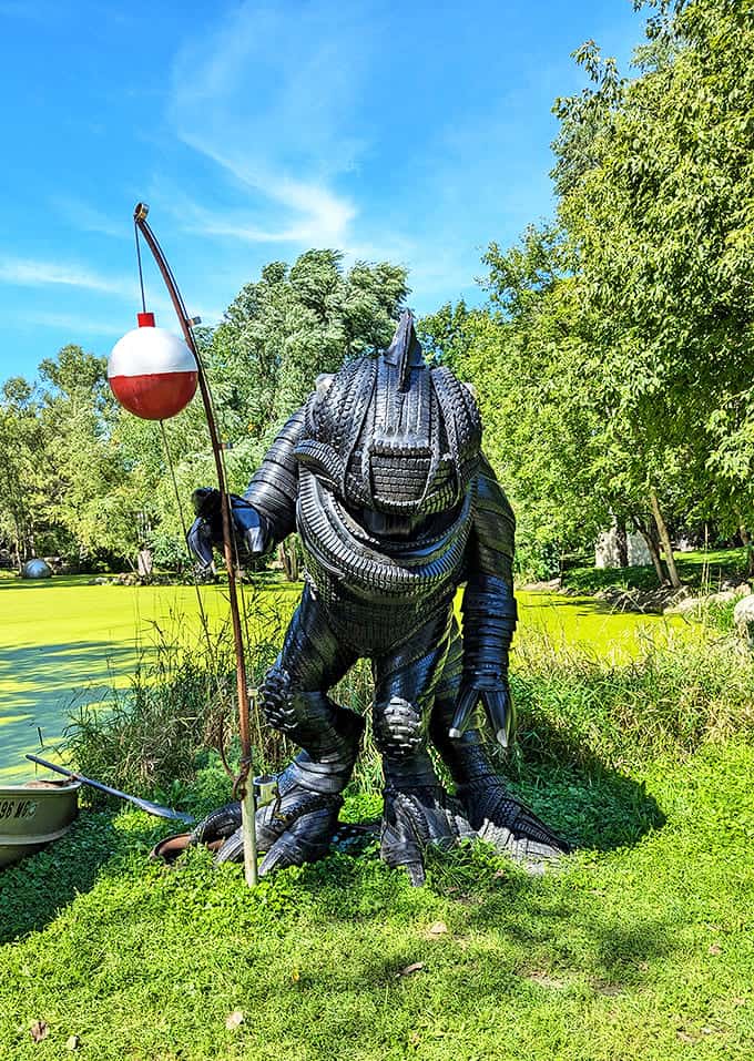 This fearsome fishing creature stands guard by the pond, fishing rod eternally poised as if waiting for the perfect catch.