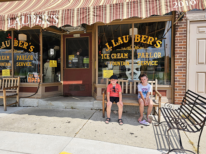 Two young explorers stake their claim outside this time-traveling establishment, ready to make memories that'll probably outlast their sugar rush, though that's saying something.