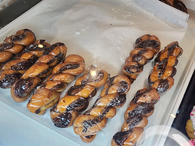 Glazed Twists: Glistening spirals of dough that hypnotize with their perfect golden hue &ndash; like edible DNA strands carrying the genetic code for happiness.