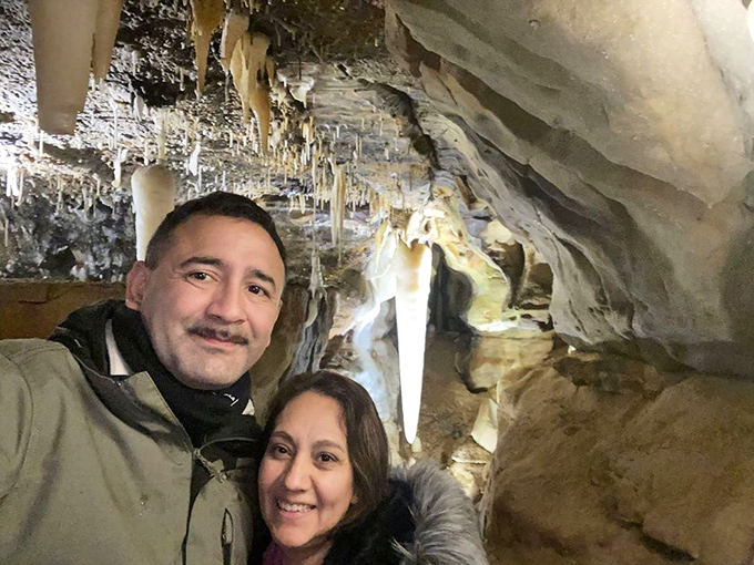 Happy cave explorers capture a selfie moment surrounded by formations that have been growing since before recorded history began.