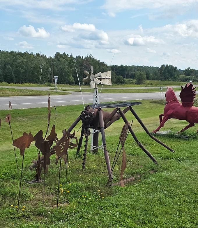 Metal creatures fashioned from farm tools graze the lawn like a whimsical mechanical menagerie.