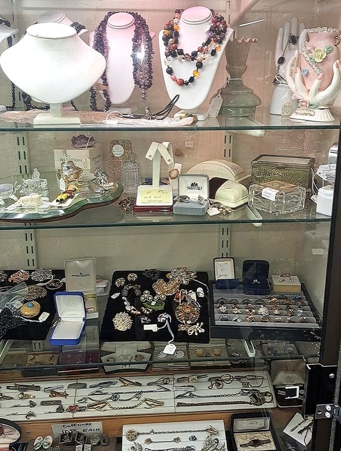 Sparkling vintage jewelry displayed in glass cases offers treasures from bygone eras, each piece carrying stories of the hands that once wore them to dances, dinners, and special occasions.