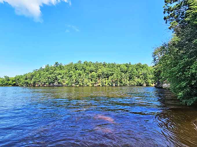 The lake stretches out peacefully, reflecting trees and sky like nature's own high-definition mirror.