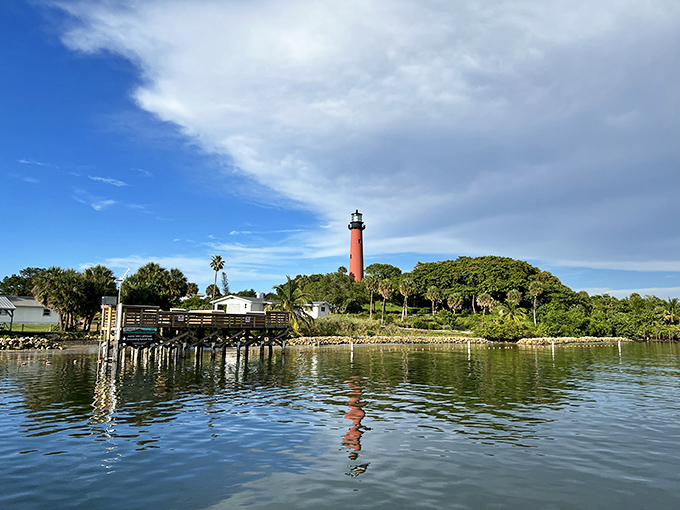 From across the inlet, the lighthouse creates a perfect reflection, doubling its majesty in nature's mirror.