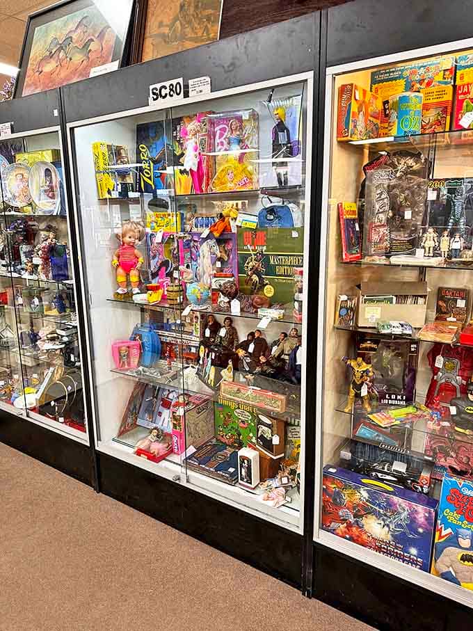 Behind these glass panels, action figures and collectibles stand frozen in time, their original packaging intact and values steadily climbing.