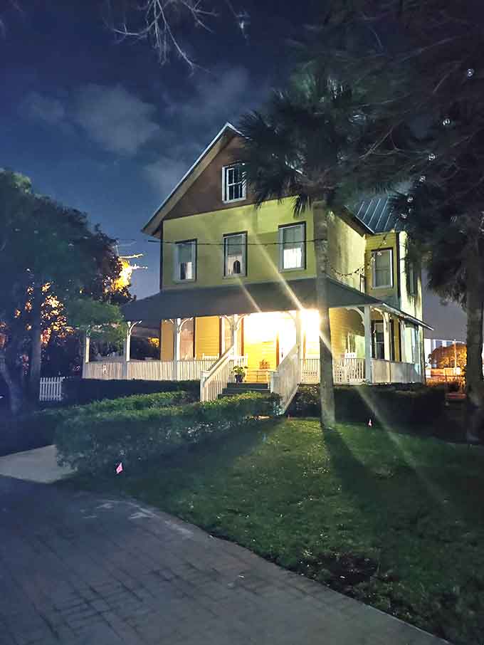 Evening transforms the cheerful yellow house into an eerie silhouette where windows sometimes reveal unexplainable shadows.
