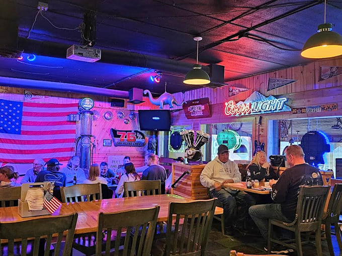 Neon signs cast their colorful glow across wooden tables where countless stories have been shared over cold beers and hot pizza.