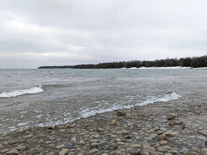 Winter transforms the shoreline into nature's rock collection, polished by waves and waiting for discovery.