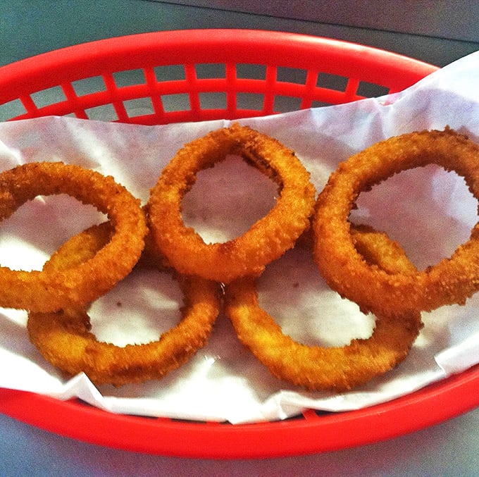Golden, crispy onion rings that shatter with each bite &ndash; the perfect sidekick to any of their 108 burger creations.