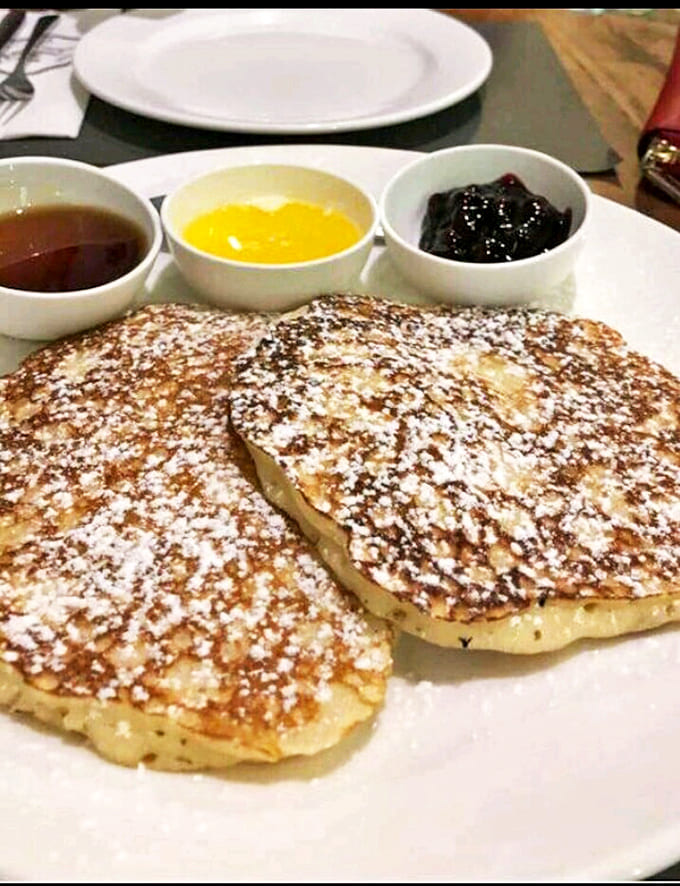 These fluffy discs of joy, dusted with powdered sugar and served with a trio of toppings, make mornings worth getting up for.