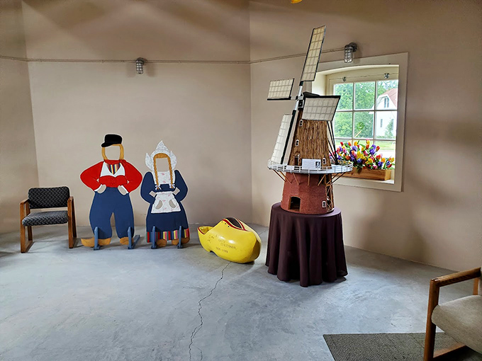 The Van Asten Visitors Center welcomes guests with its distinctive brick architecture and blue doors, complementing the windmill's authentic design.