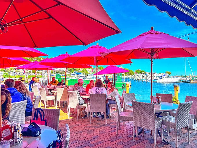 Pink umbrellas dot the waterfront patio, offering the island's most coveted dining spots with unobstructed harbor views.