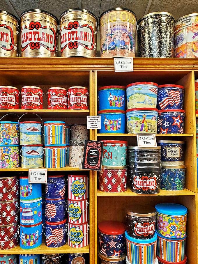 Decorative popcorn tins line the shelves like colorful soldiers, ready to march home with you and become permanent kitchen fixtures long after the popcorn disappears.