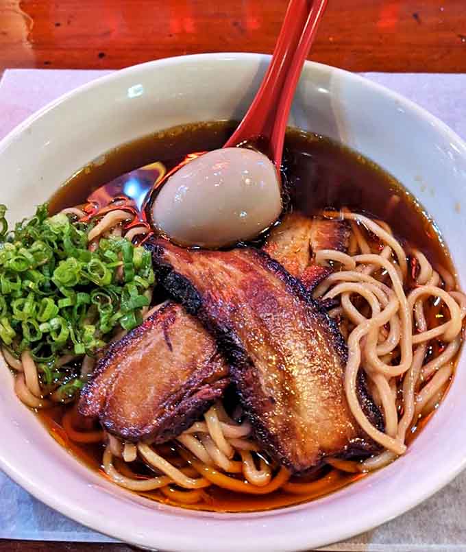 Surprising sophistication in a bowl &ndash; tender noodles swimming in rich broth with perfectly seared pork belly and a soft-boiled egg.